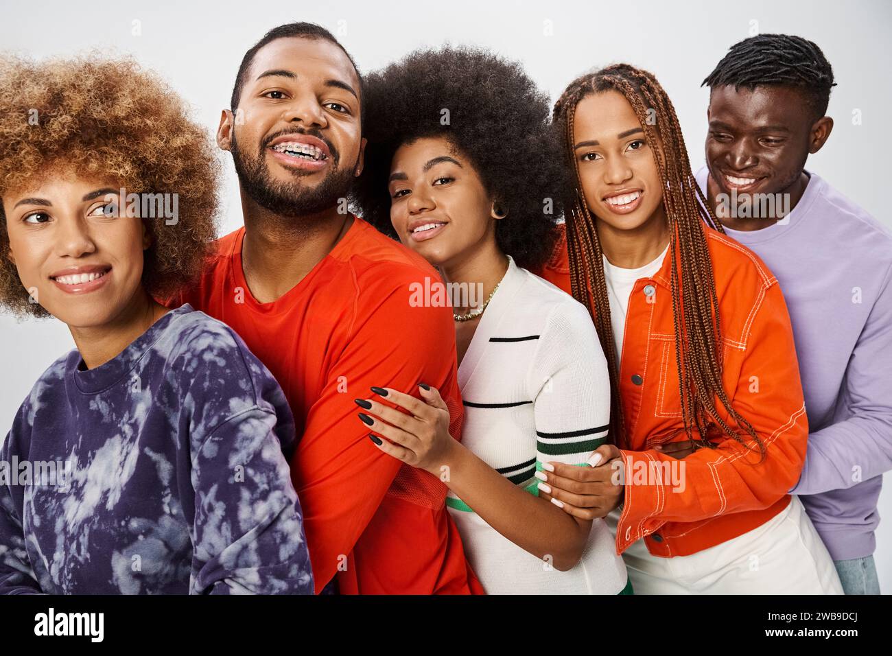cheerful african american community in casual attire hugging each other ...