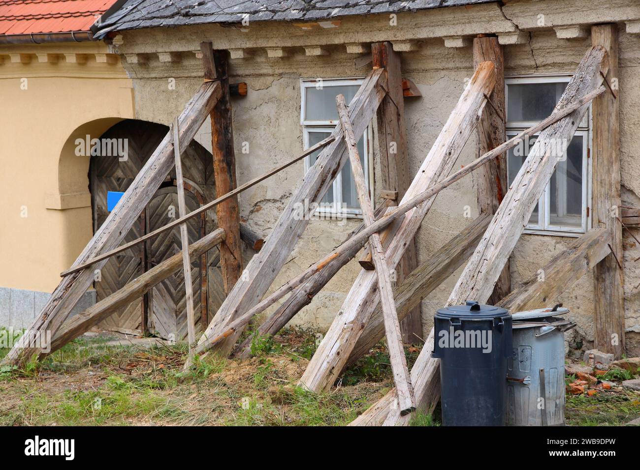 Temporary wooden beam supports holding a house in Koszeg, Hungary ...
