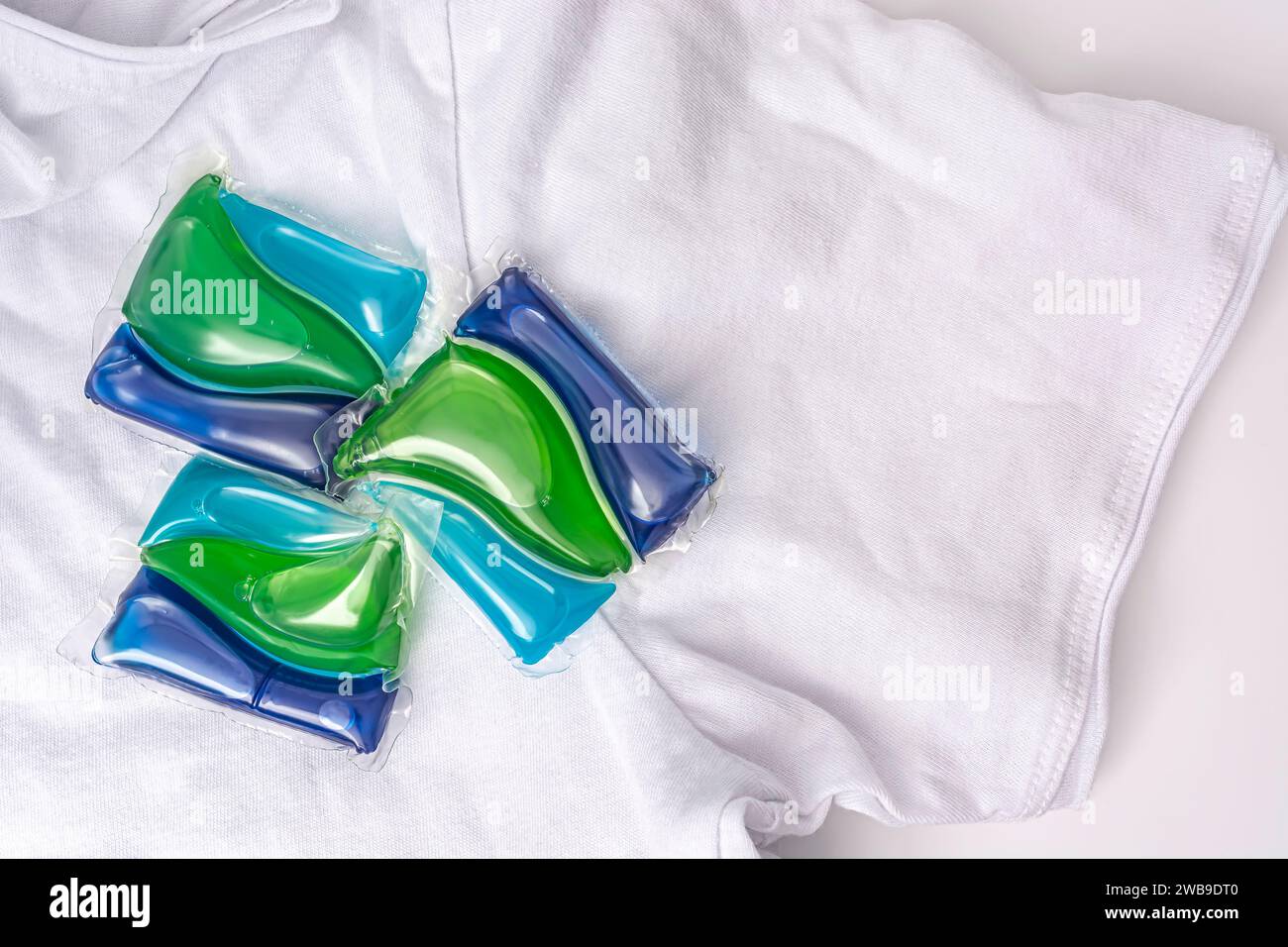 square wash capsule with gel on white knitted fabric Stock Photo - Alamy