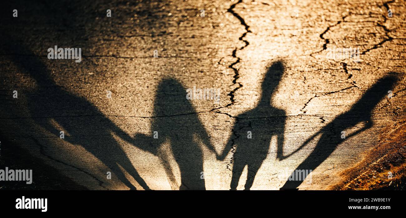 Shadow silhouette at sunset. Newlyweds and maid of honor and best man ...