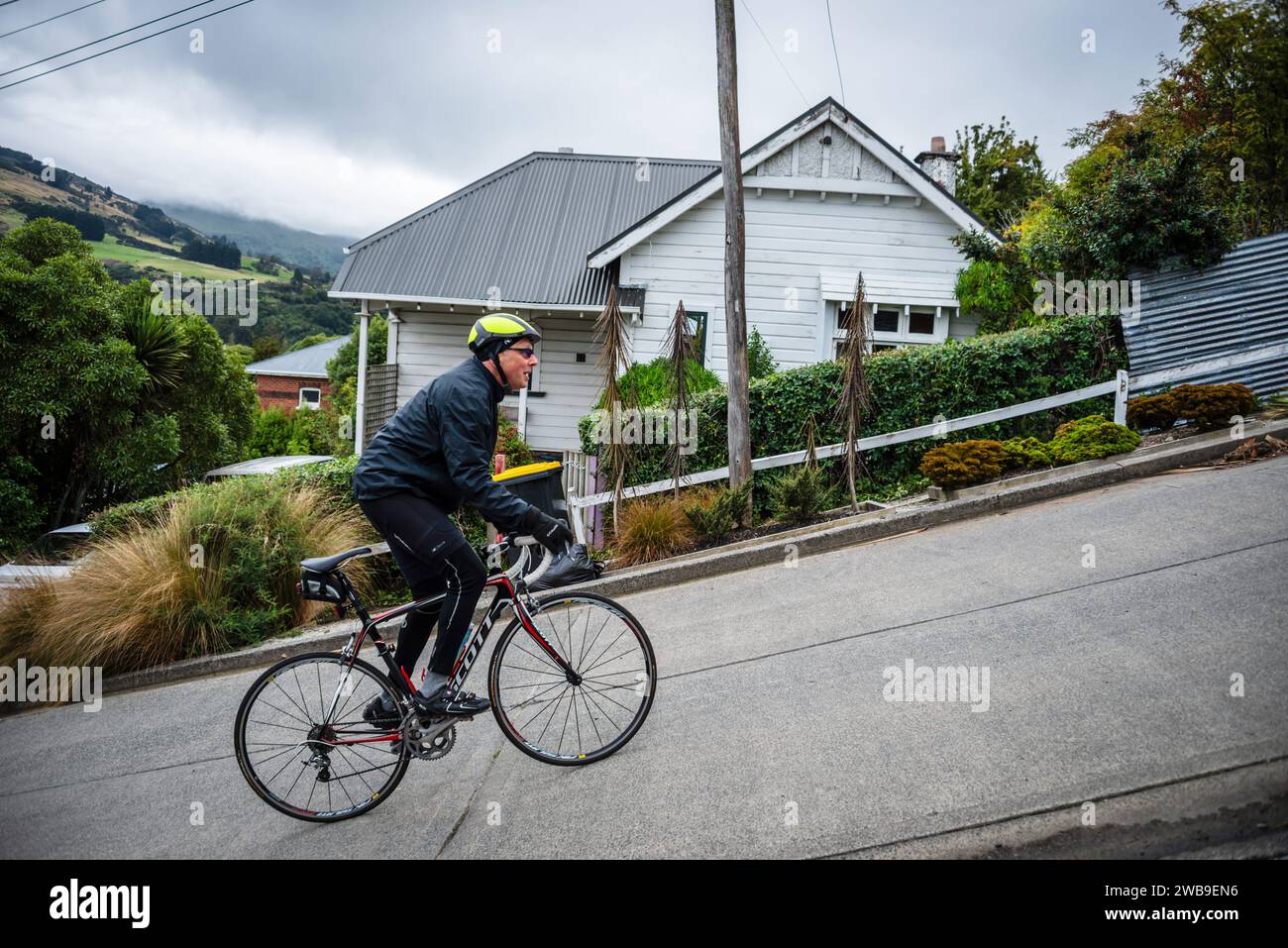 A male road cyclist battles to ride up Baldwin Street, Dunedin, the ...