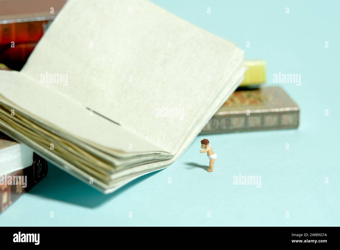 Miniature tiny people toy figure photography. Read concept. A boy ...