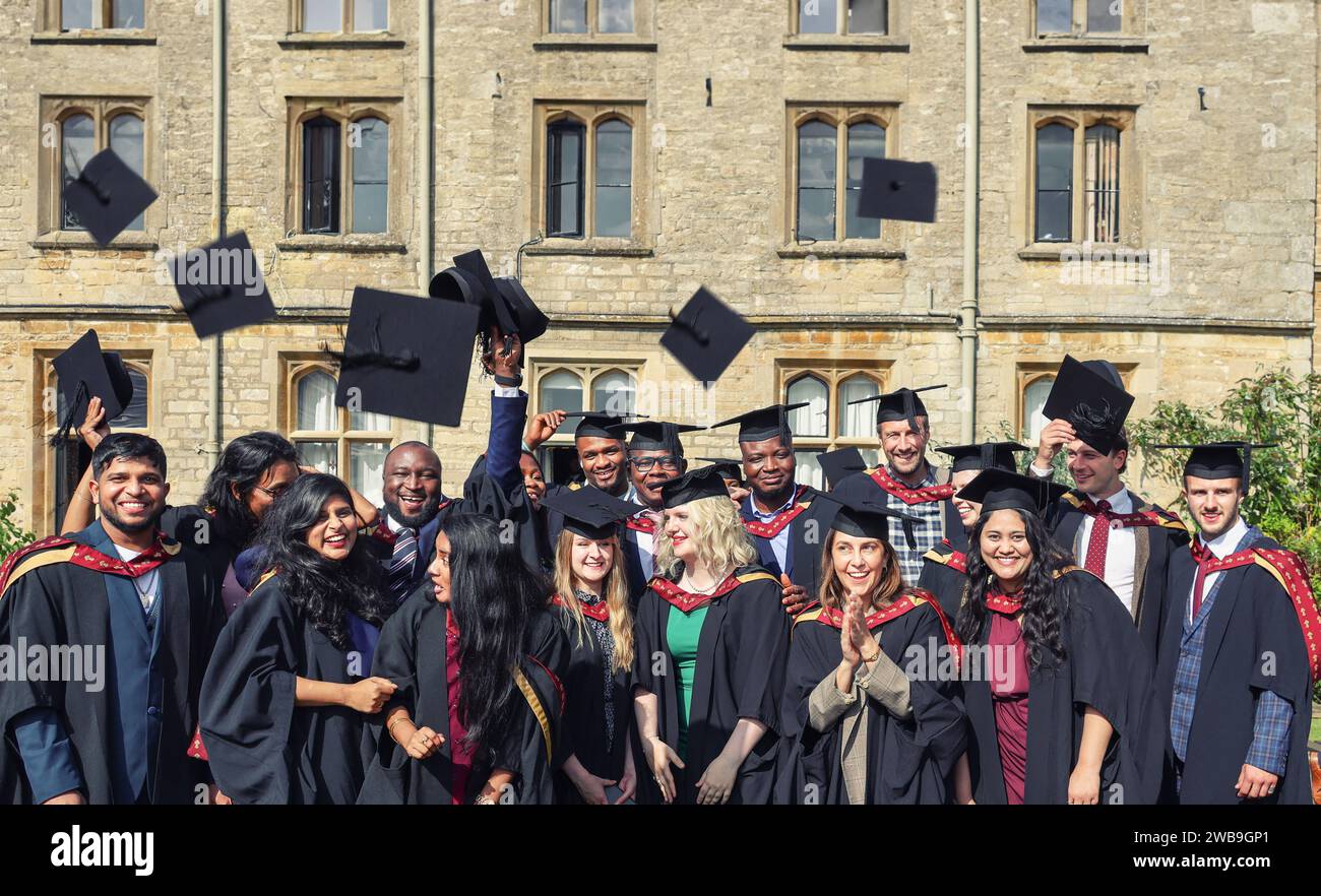Happy group of multiratial graduates celebrating their Masters degree ...
