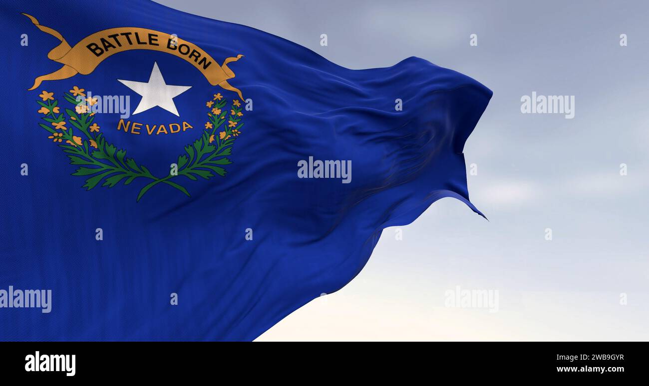 Close-up of Nevada state flag waving in the wind on a clear day. Cobalt ...