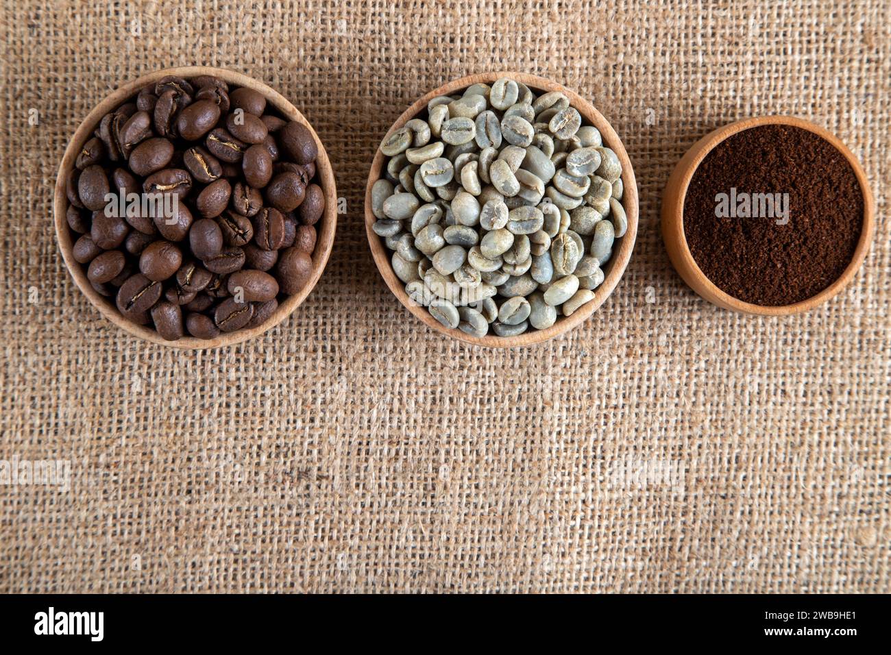 Ground coffee with roasted coffee beans on burlap,top view Stock Photo ...