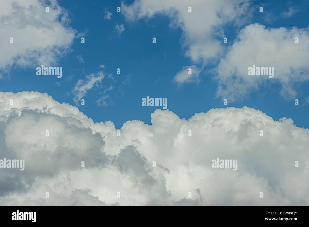 Clouds in the blue sky at day. Sunny moment with summer clouds. Background and textures for a ...