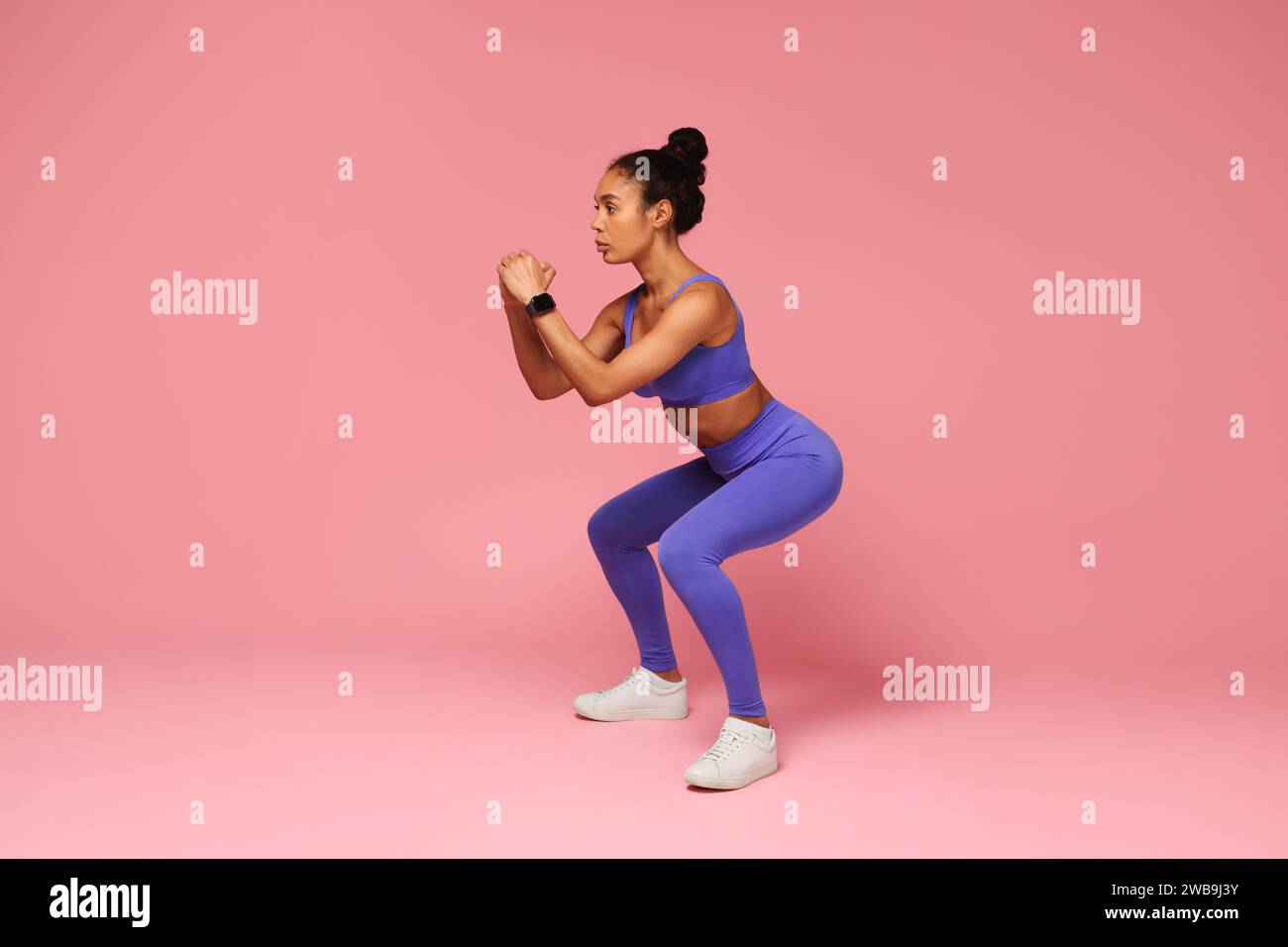 Determined Sporty Young Black Lady Doing Deep Squat Exercise, Studio ...