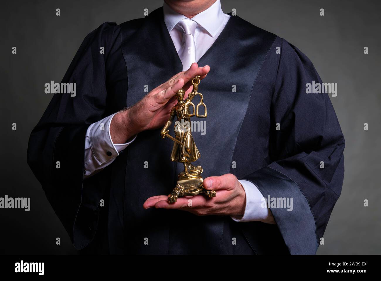 german lawyer with a classical black robe and white tie holding a ...