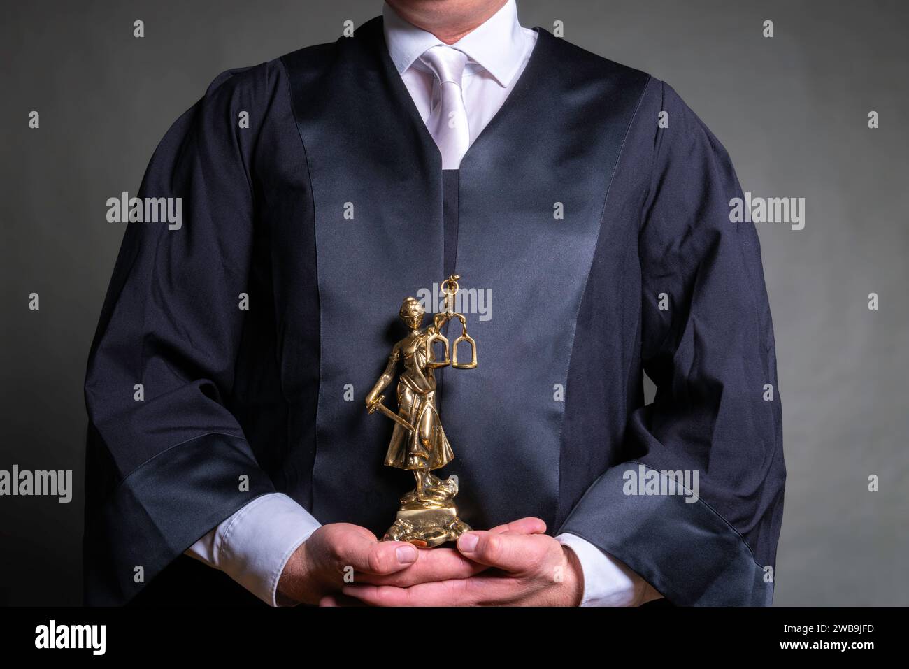 german lawyer with a classical black robe and white tie holding a ...