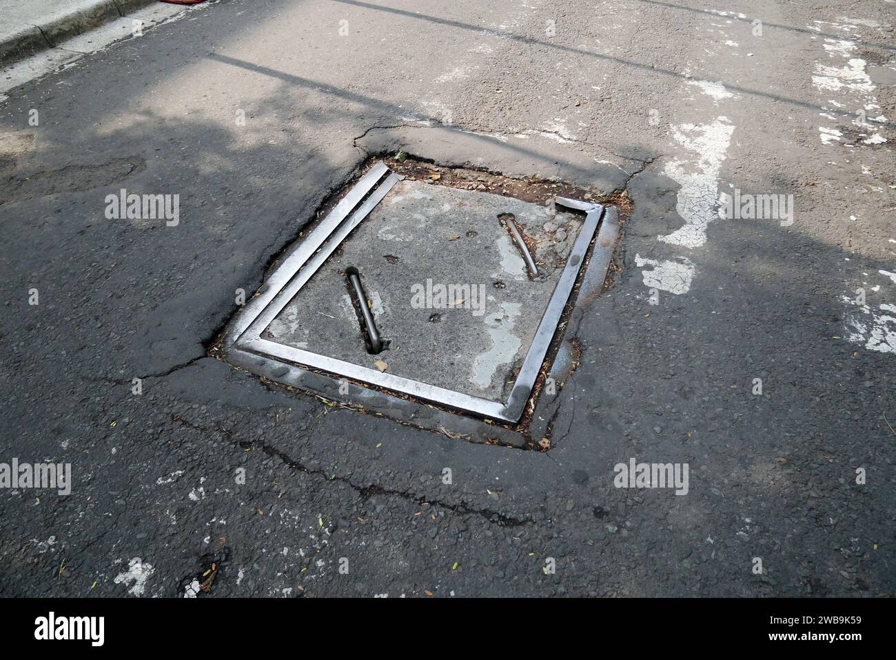 Manhole safety drain cover on paved floor. Water absorption channel ...