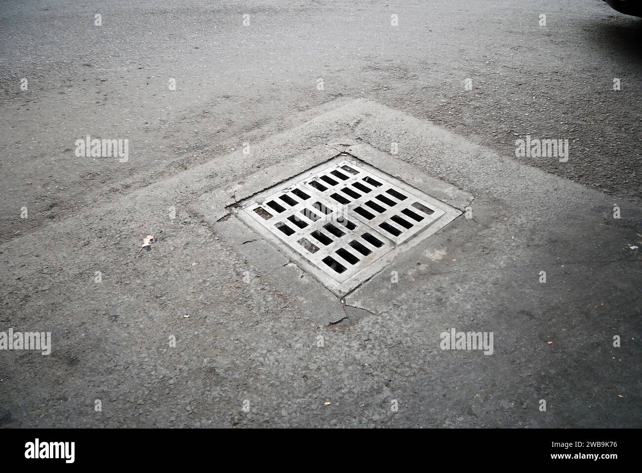Manhole safety drain cover on paved floor. Water absorption channel ...
