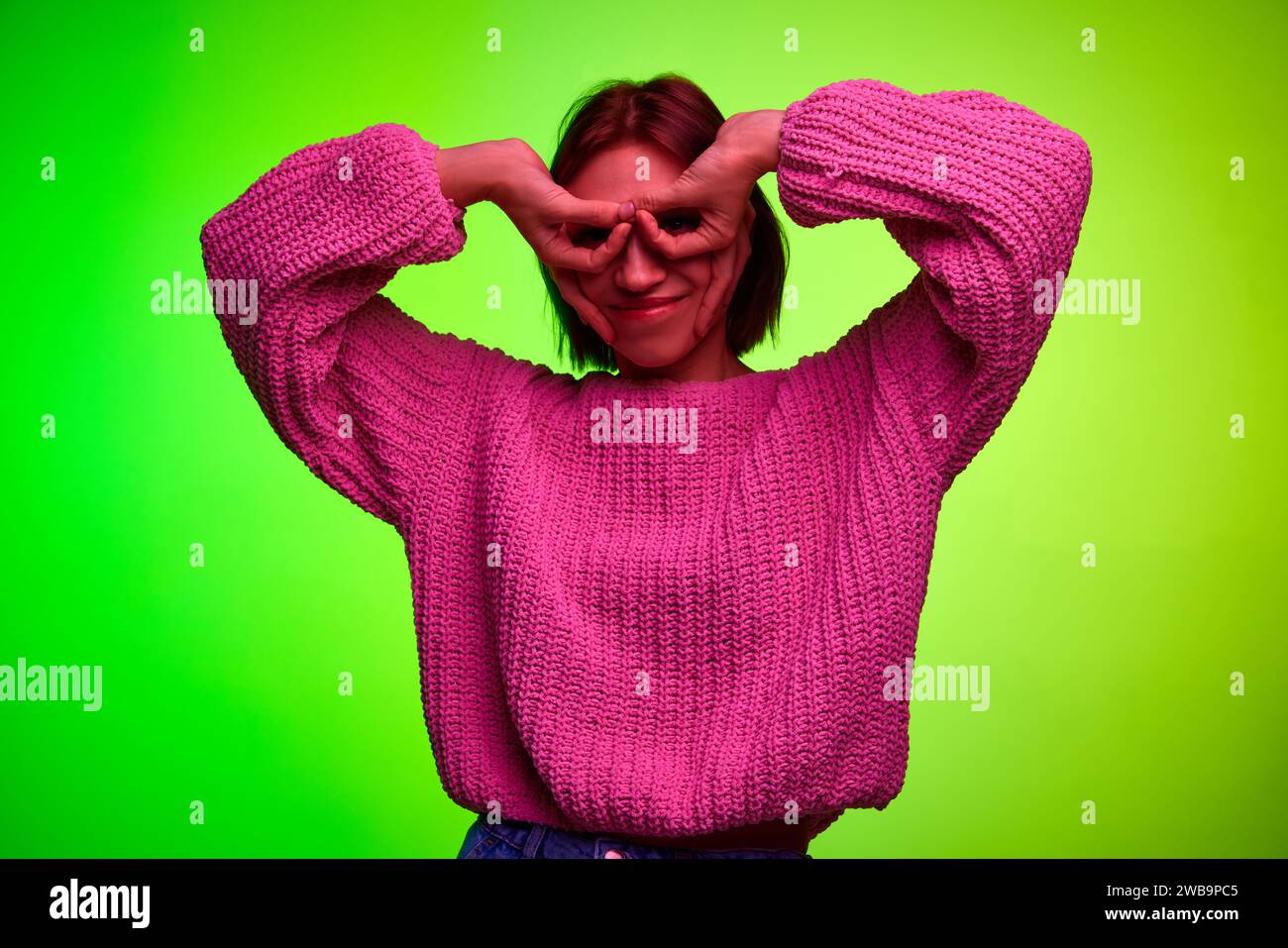 Portrait of young funny woman grimacing to camera against gradient ...