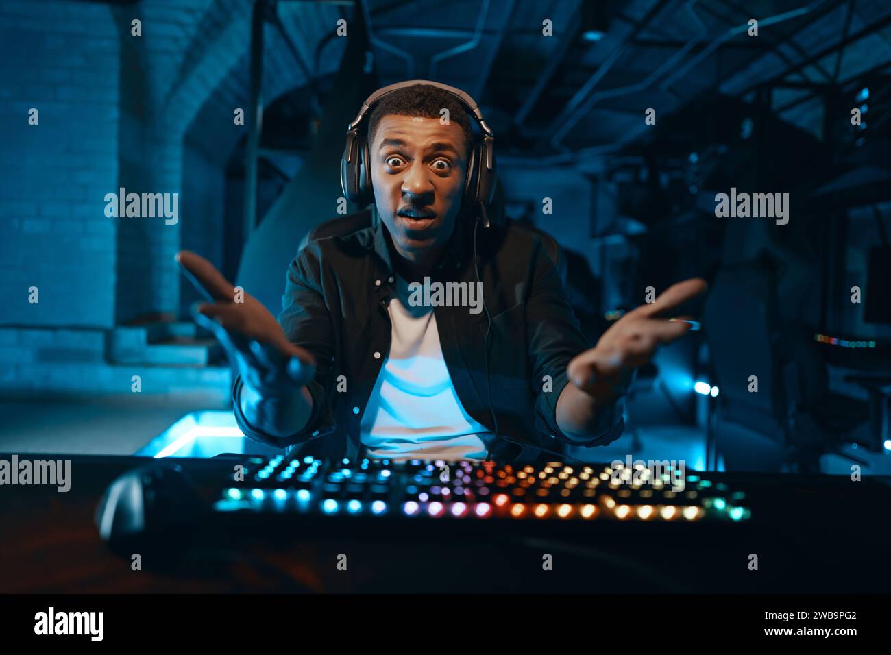 Surprised gamer with a vivid keyboard reacts during gameplay Stock ...