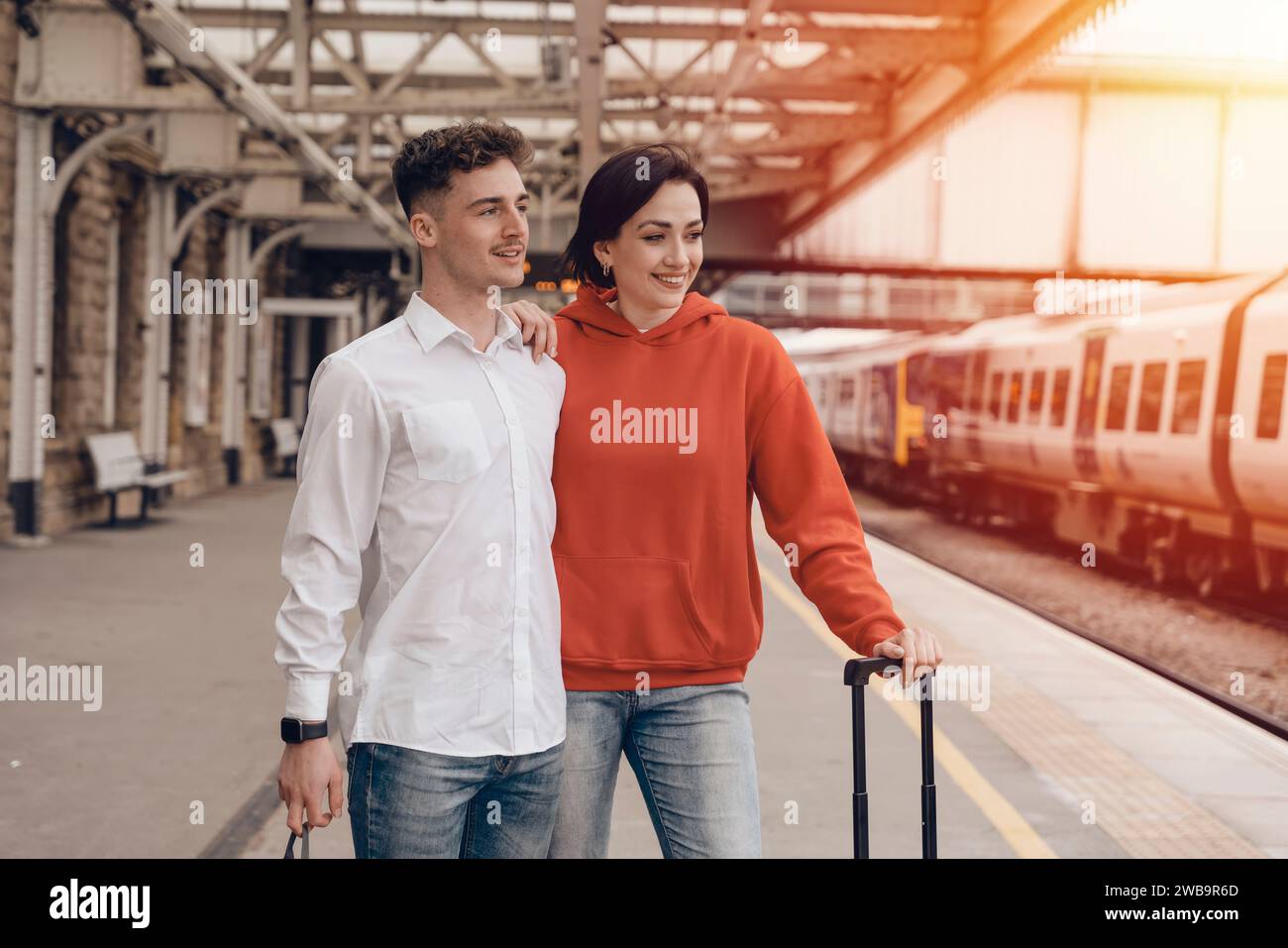 Beautiful couple at railway station waiting for the train. Woman and ...