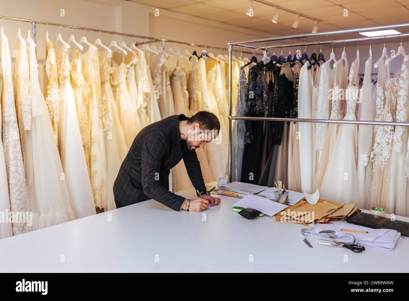 Male fashion designer creating a new collection of clothing Stock Photo ...