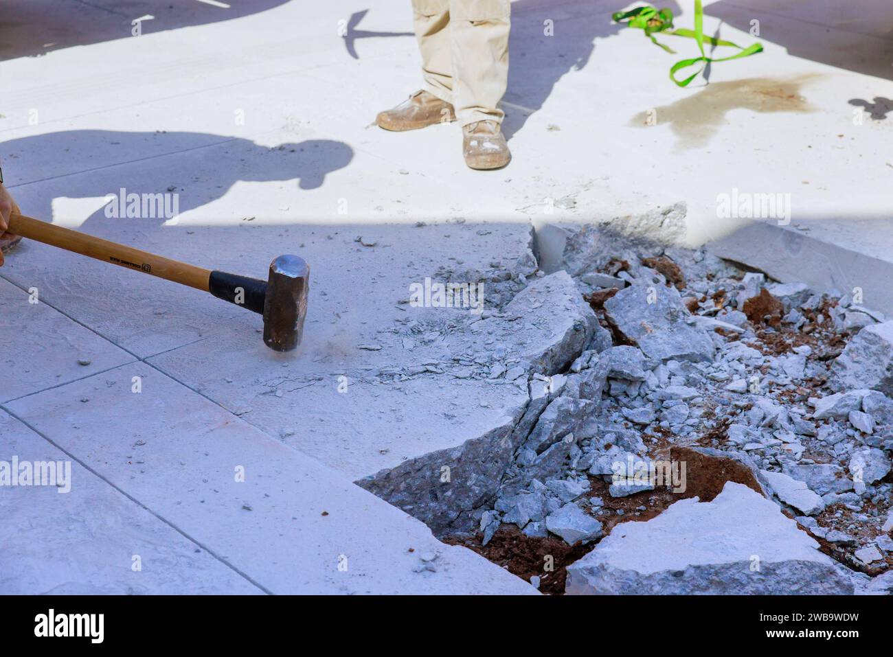 Repairing works for destroyed concrete sidewalk paving after demolition ...