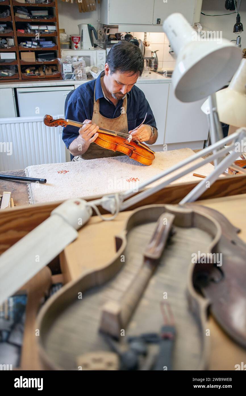 violin maker in his workshop. photo: Bo Arrhed Stock Photo - Alamy