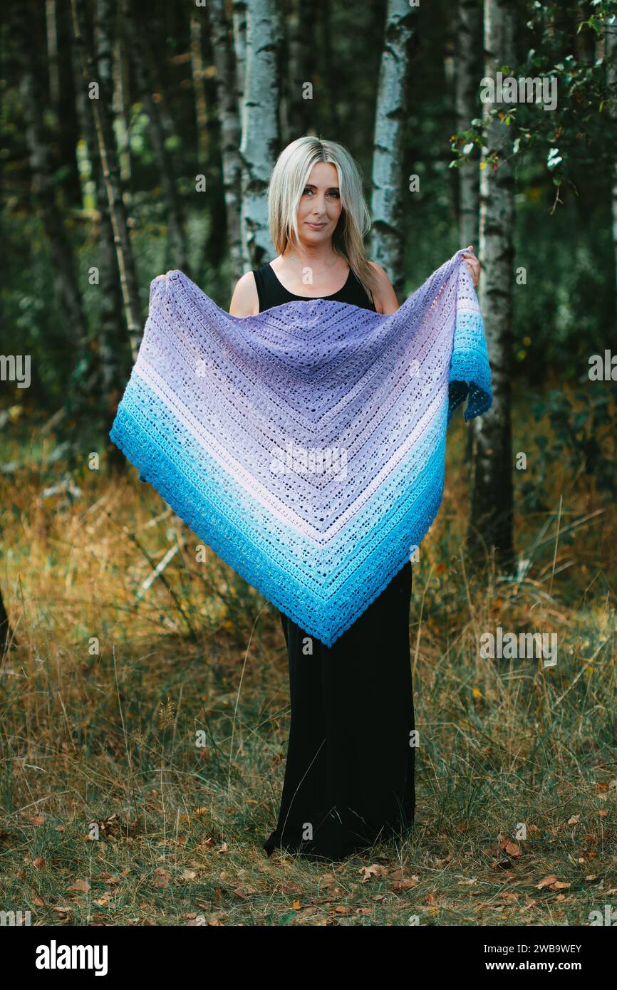 Fourty years old woman show hand crochet made by herself ombre shawl in ...