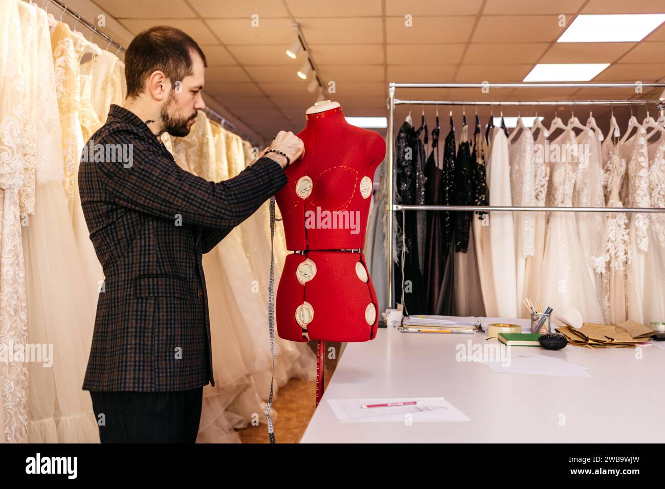 Serious male fashion designer drawing sketch of new clothes collection ...