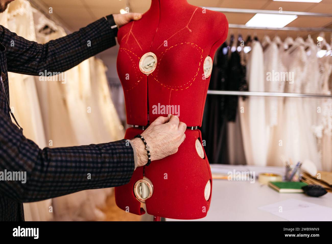 Serious male fashion designer drawing sketch of new clothes collection ...