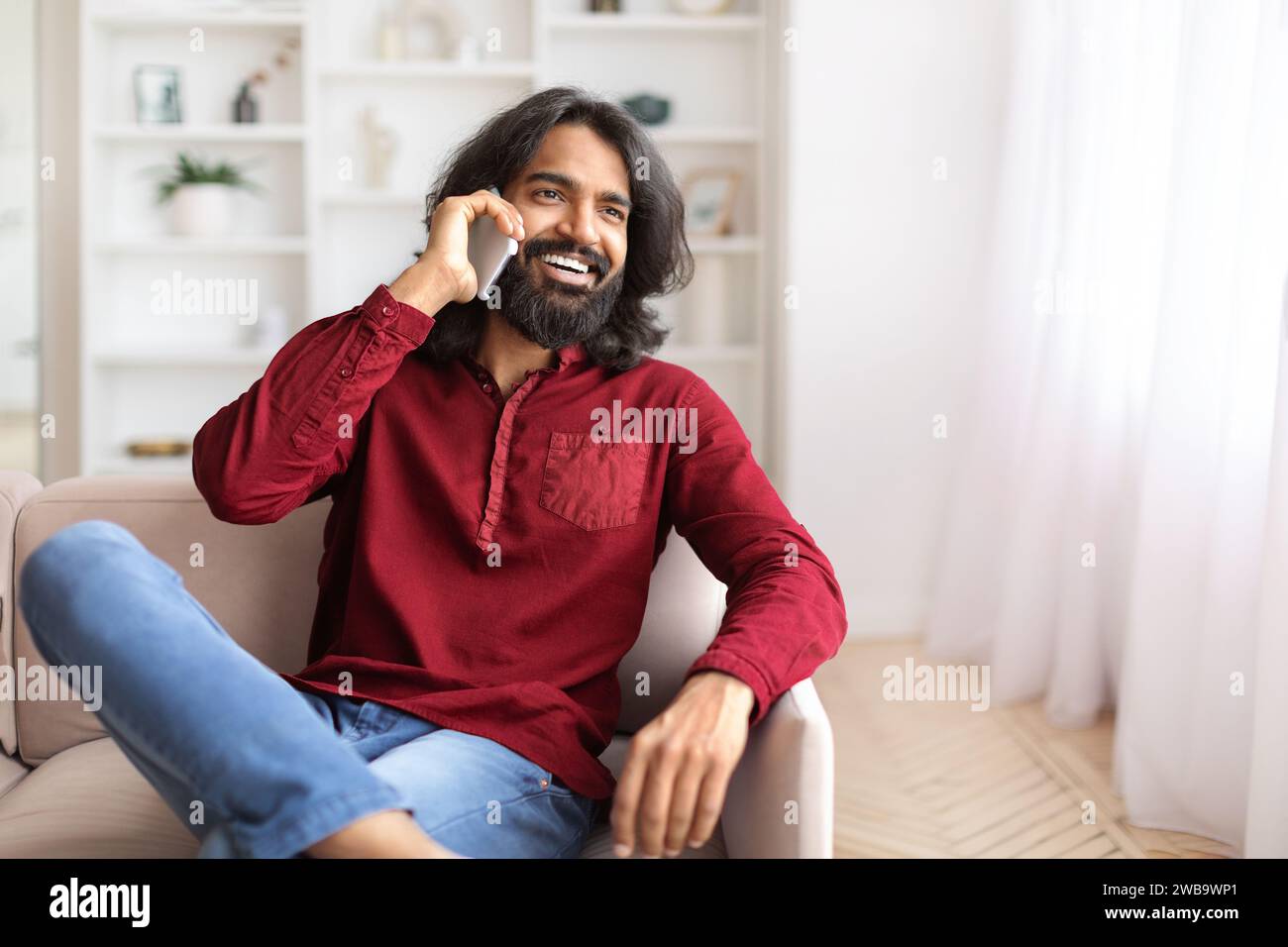 Happy young indian man have phone conversation at home Stock Photo - Alamy