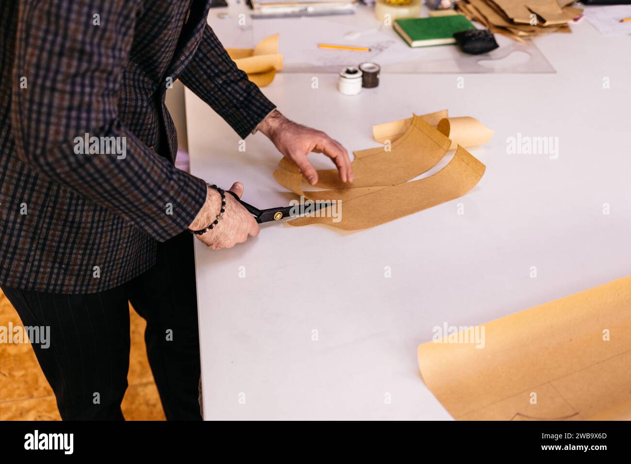 Hand scissor fabric. Cutting fabric closeup. Tailor at work Stock Photo ...