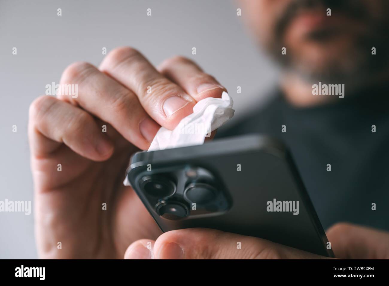 Man cleaning mobile phone device with wet wipe, selective focus Stock ...