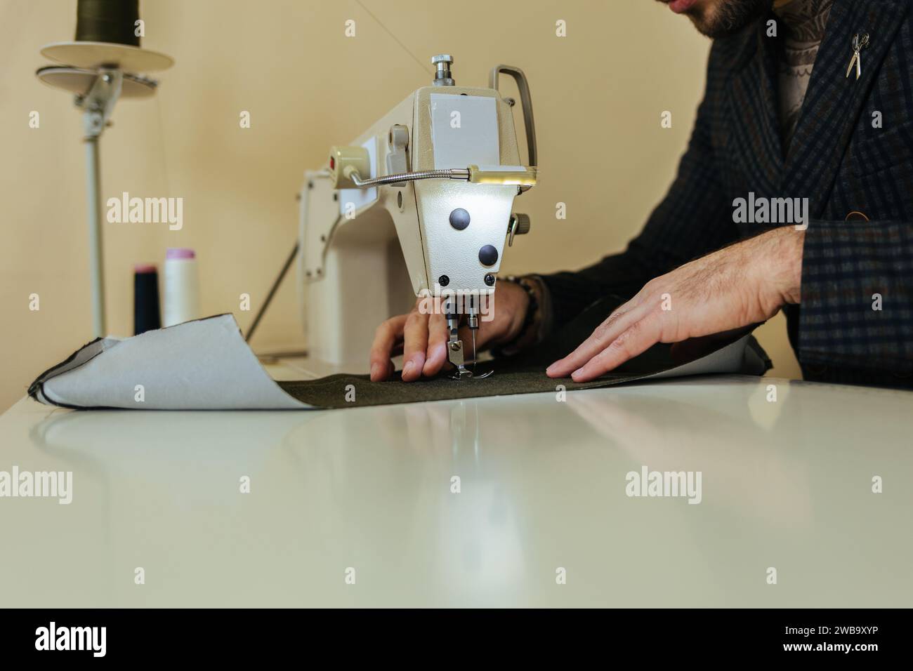 pattern, scissors, tape measure, and a sewing machine. Workplace of ...