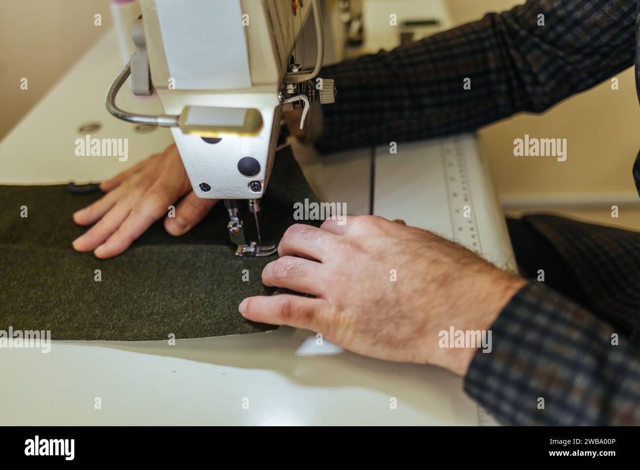 Image of seamstress working on sewing machine Stock Photo - Alamy