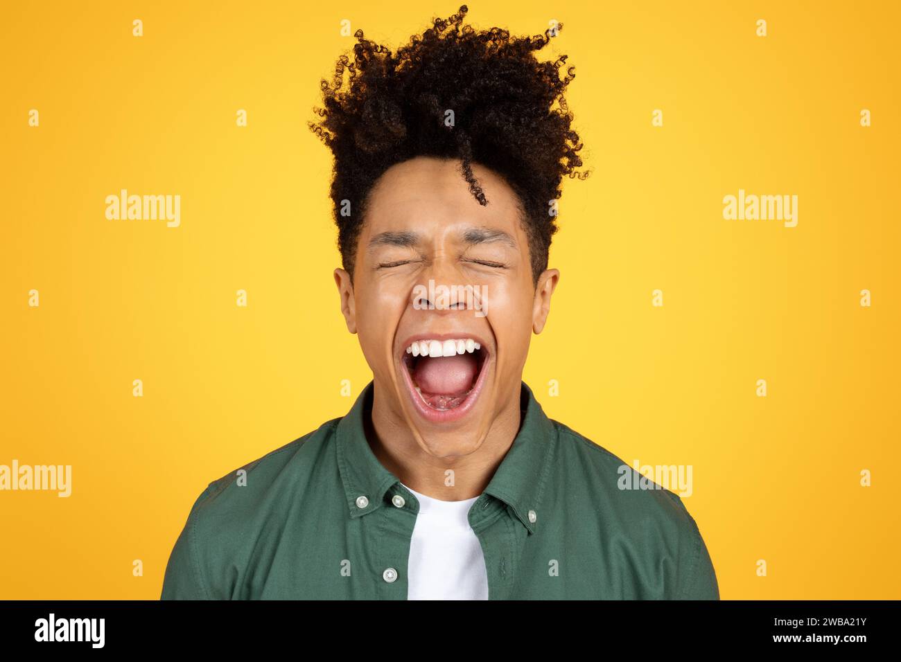 Young black man shouting out of joy, yellow background Stock Photo - Alamy