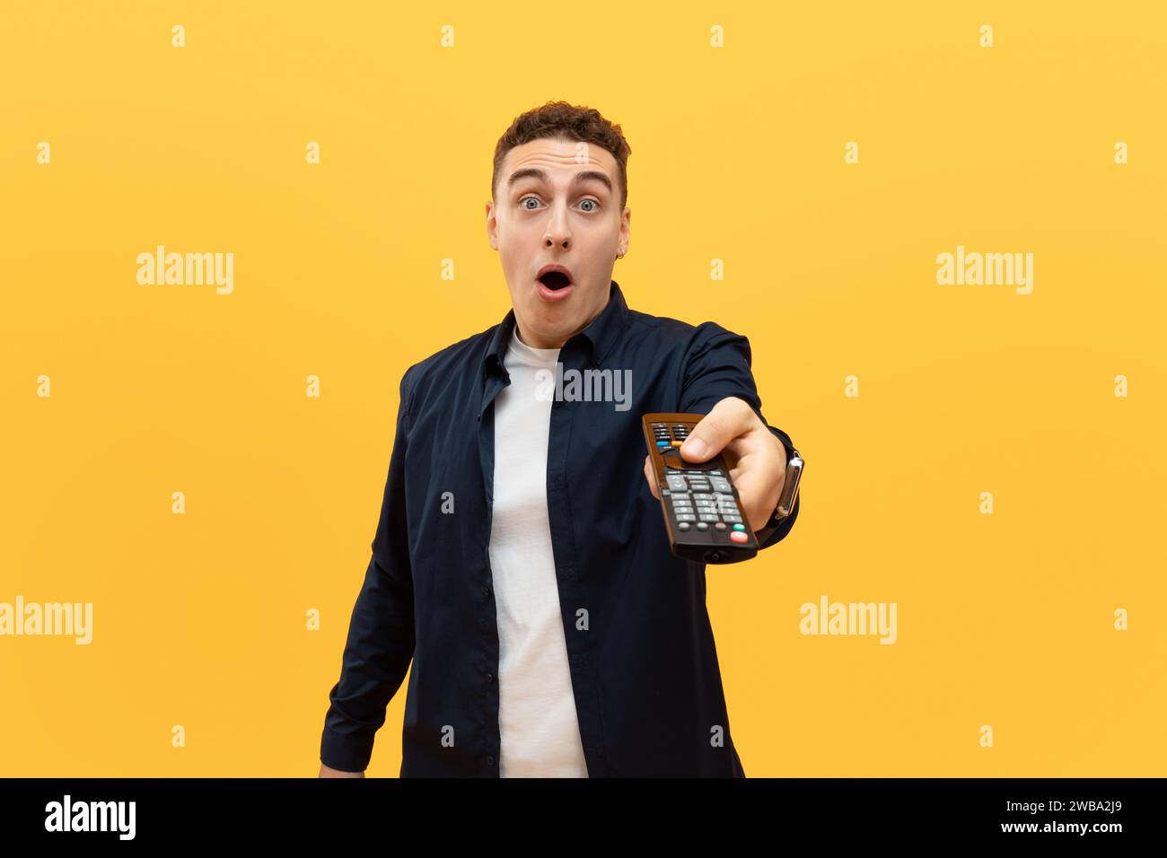 Portrait of excited handsome guy watching TV show or film Stock Photo ...