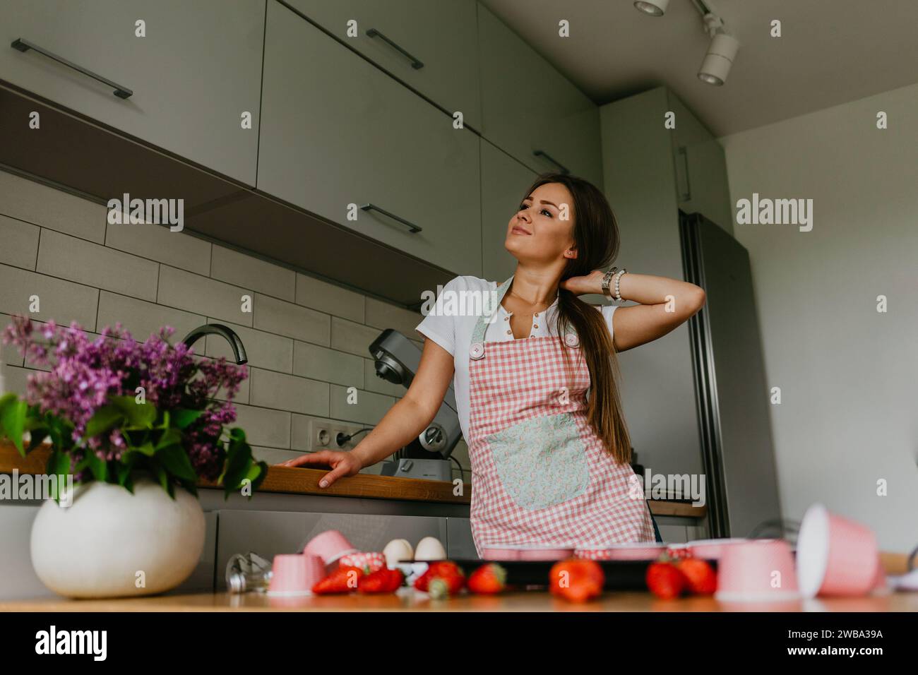 Happy baking cooking woman standing in her new kitchen smiling cheerful ...