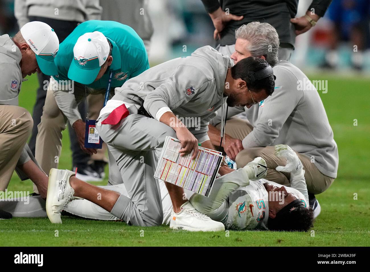 Miami Dolphins head coach Mike McDaniel is on the field with injured ...