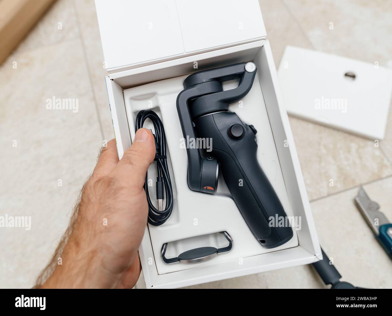 A clear image of a male hand holding a new mobile smartphone gimbal ...