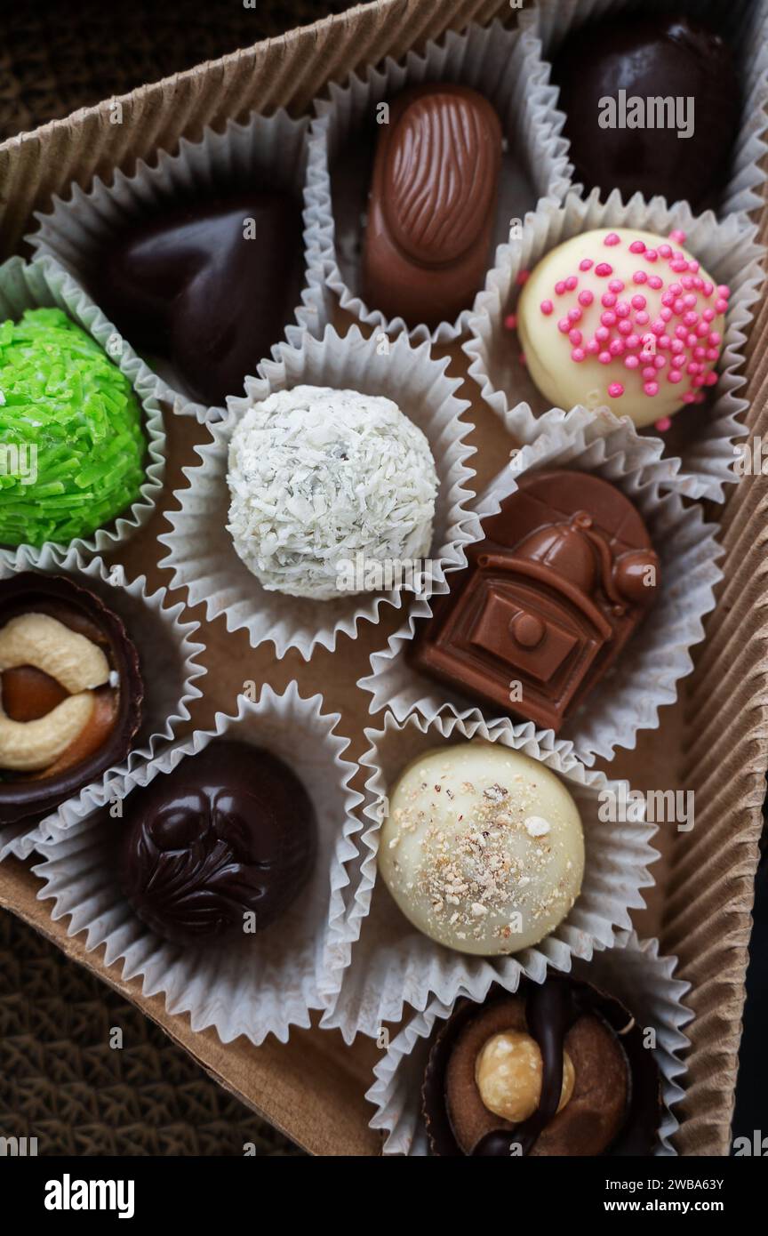 Handmade candy. White and dark chocolate with nuts in gift wrapping ...