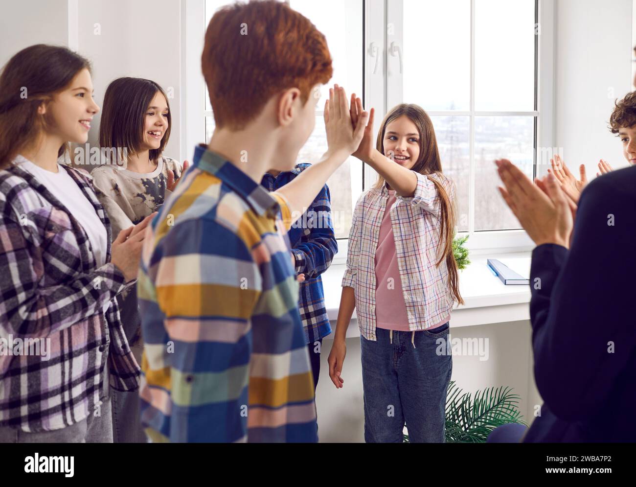 Happy school boys and girls making friends, having fun and learning ...