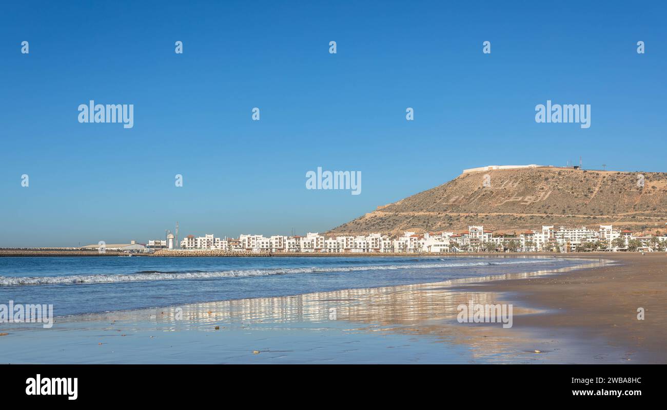 Agadir Beach and tide of Atlantic Ocean, with Kasbah and Marina in the ...