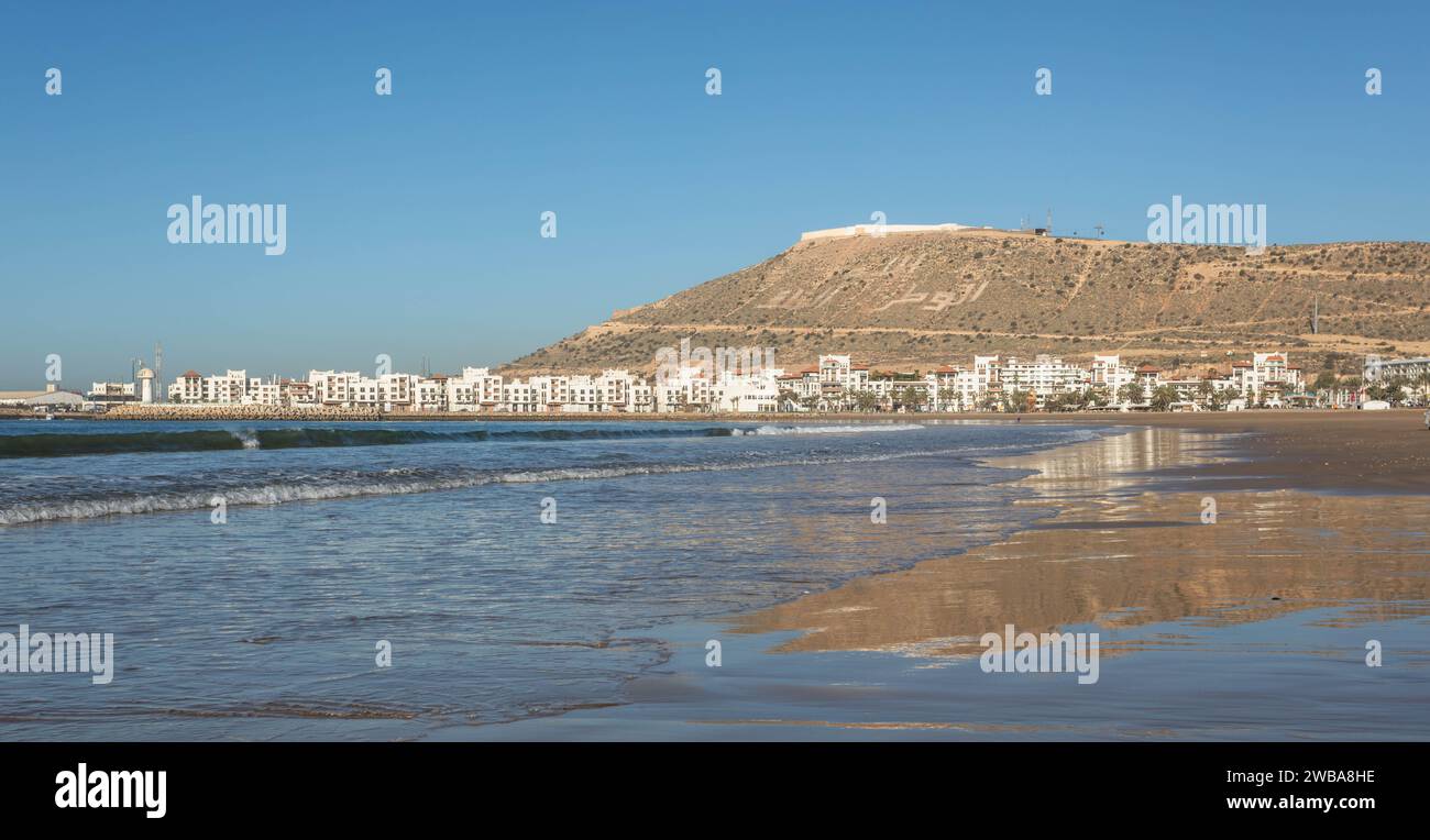 Agadir Beach and tide of Atlantic Ocean, with Kasbah and Marina in the ...