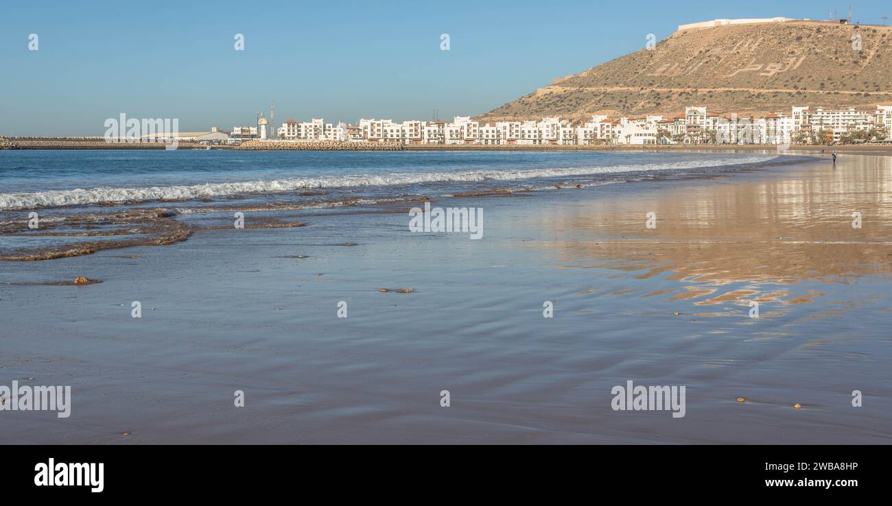 Agadir Beach and tide of Atlantic Ocean, with Kasbah and Marina in the ...
