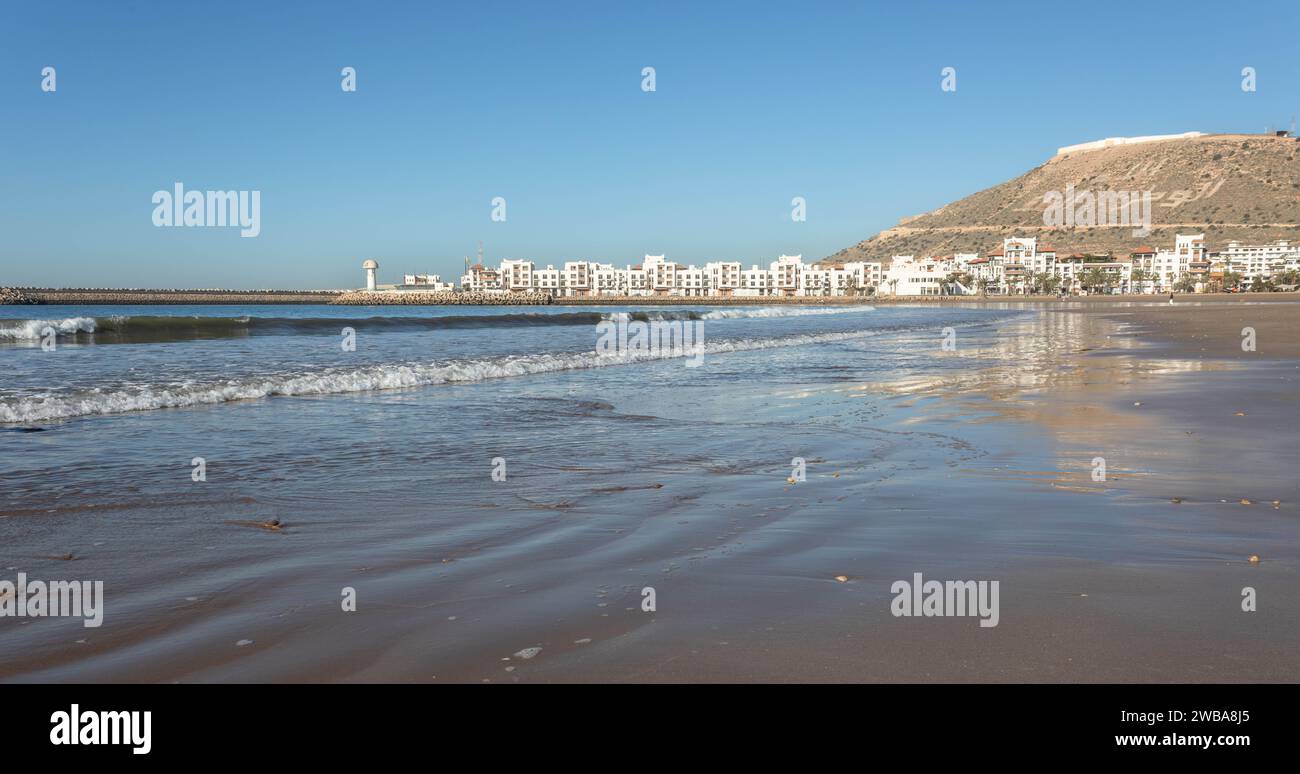 Agadir Beach and tide of Atlantic Ocean, with Kasbah and Marina in the ...