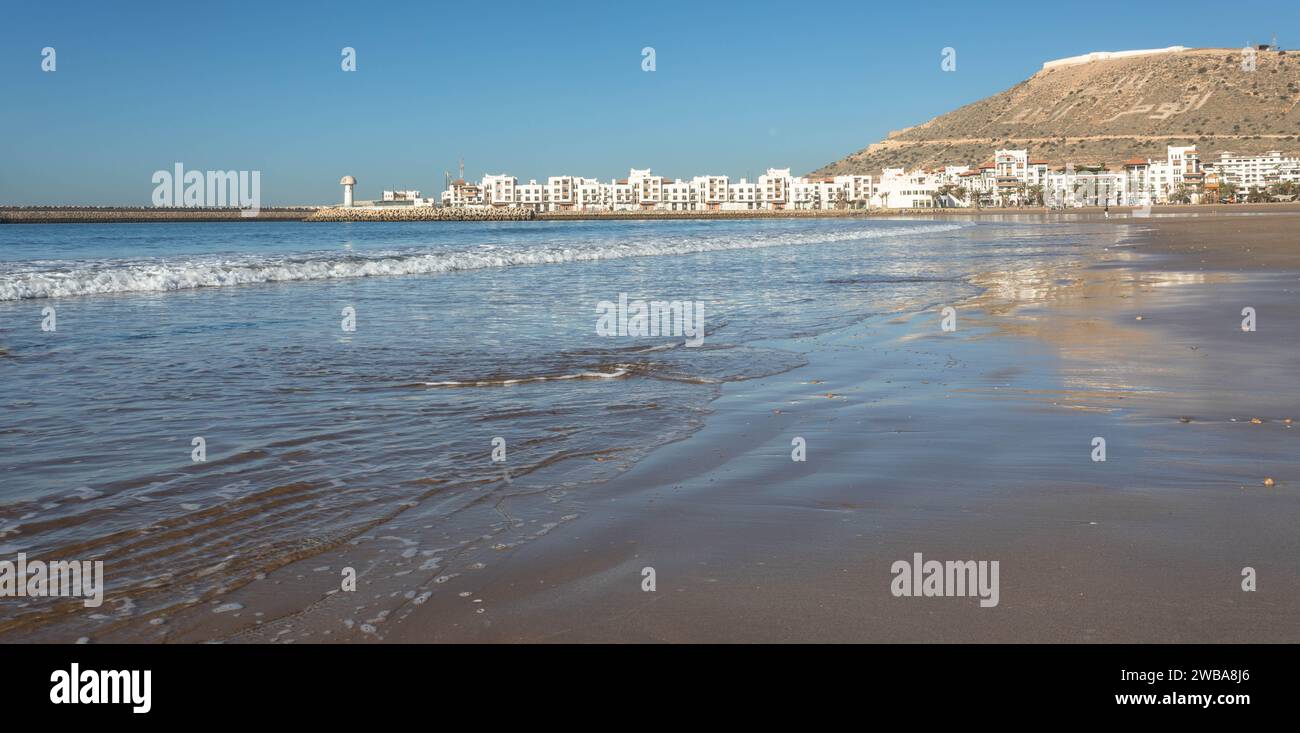 Agadir Beach and tide of Atlantic Ocean, with Kasbah and Marina in the ...
