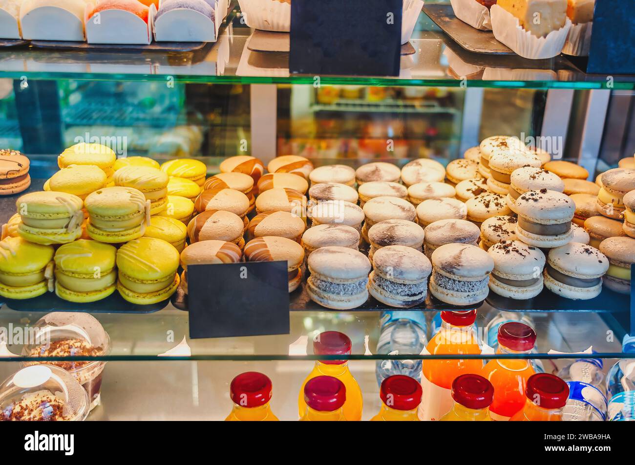 Sweets, cakes of different colors in the window of cafe store Stock ...