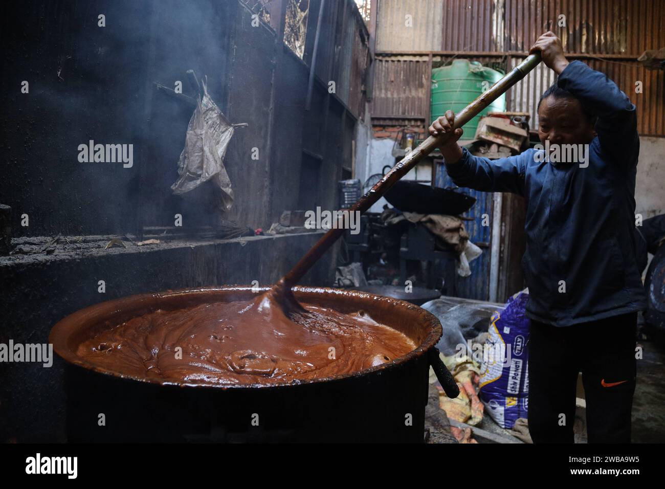 Nepal prepares molasses for Maghe Sakranti festival A Nepali worker ...