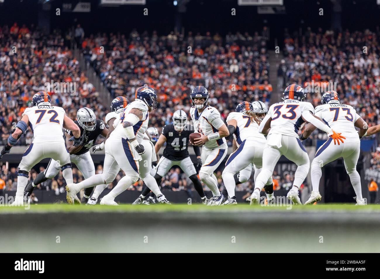Denver Broncos quarterback Jarrett Stidham (4) turns to hand off against the Las Vegas Raiders ...