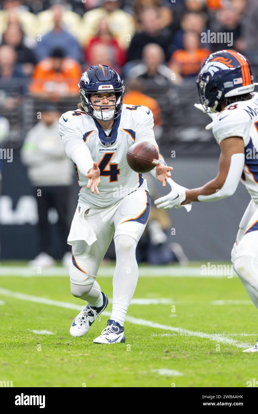 Denver Broncos quarterback Jarrett Stidham (4) tosses the ball against the Las Vegas Raiders in ...