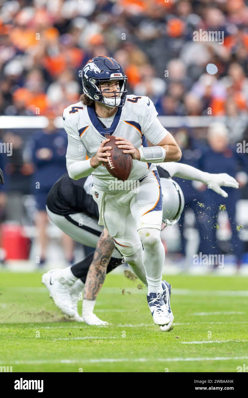 Denver Broncos quarterback Jarrett Stidham (4) scrambles against the Las Vegas Raiders in an NFL ...