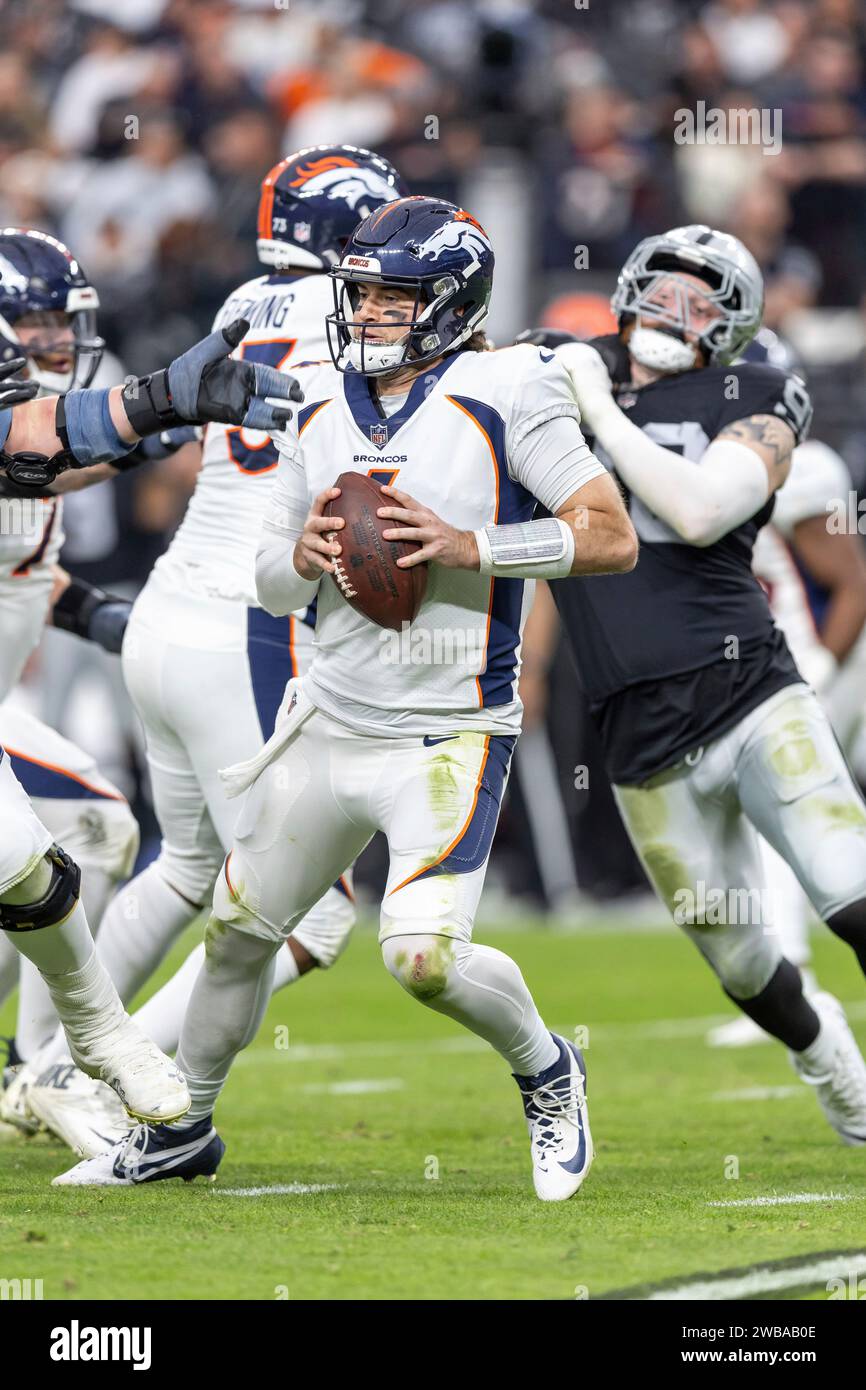 Denver Broncos quarterback Jarrett Stidham (4) scrambles against the Las Vegas Raiders in an NFL ...