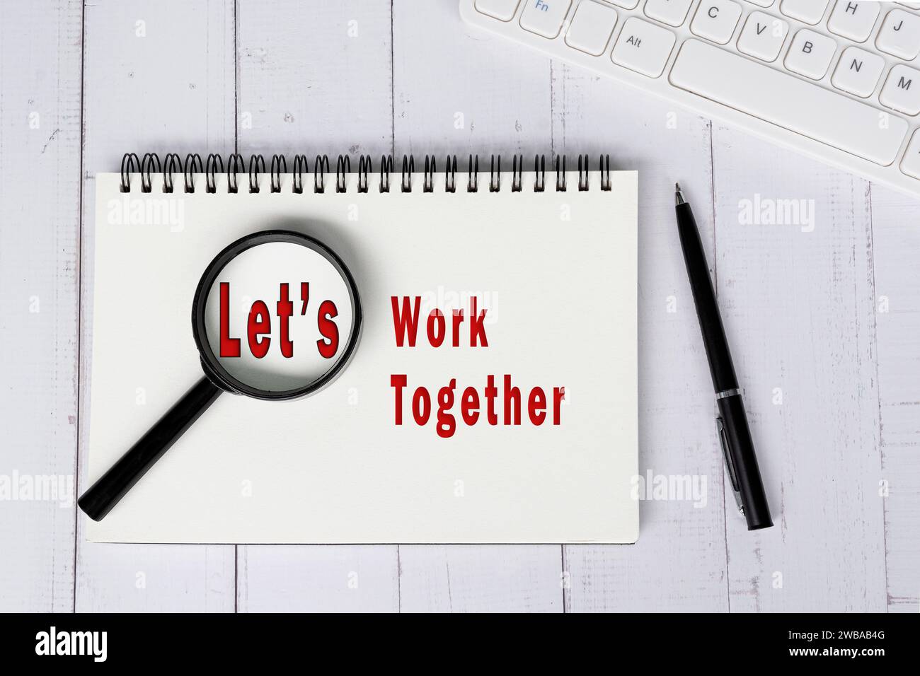 LET'S WORK TOGETHER text with magnify glass on note book on white w ...
