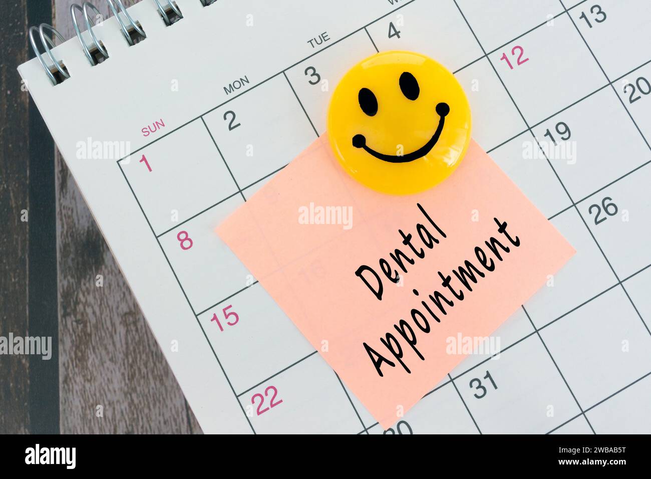 Dental Appointment text on orange paper sticky note with smiley face ...