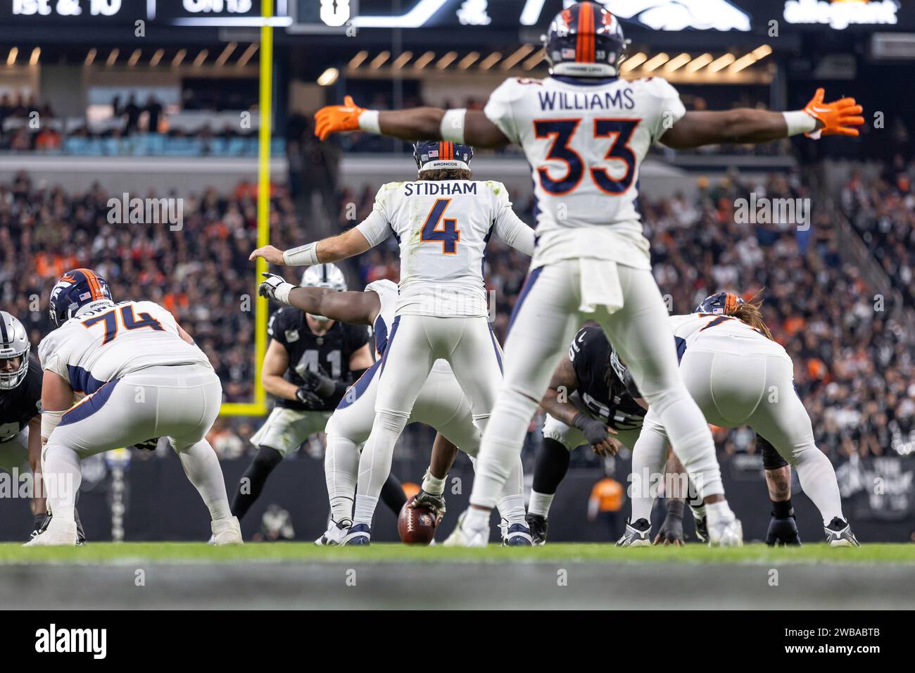 Denver Broncos quarterback Jarrett Stidham (4) audibles at the line of ...